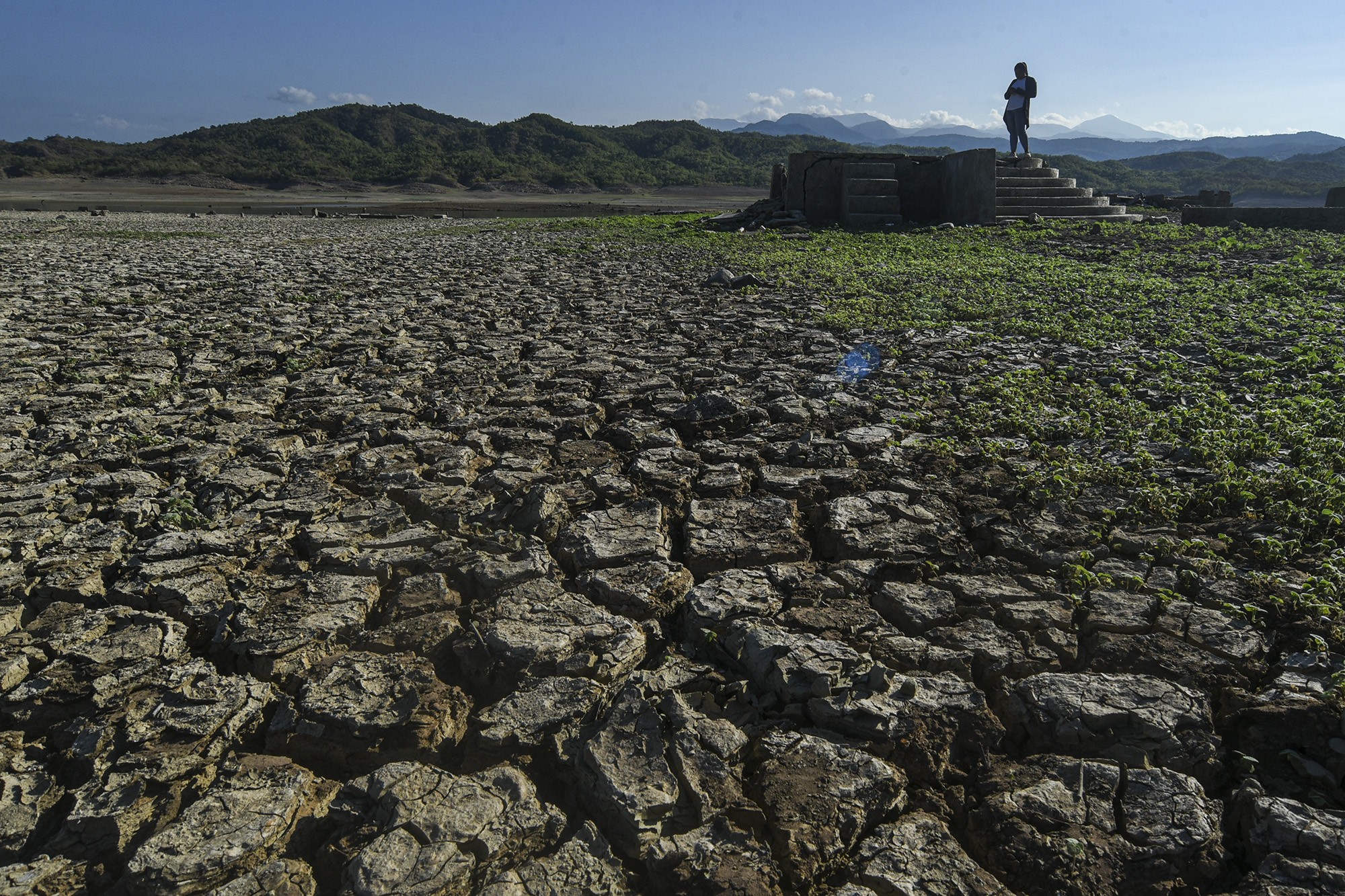 Philippine settlement submerged by dam reappears due to drought ...
